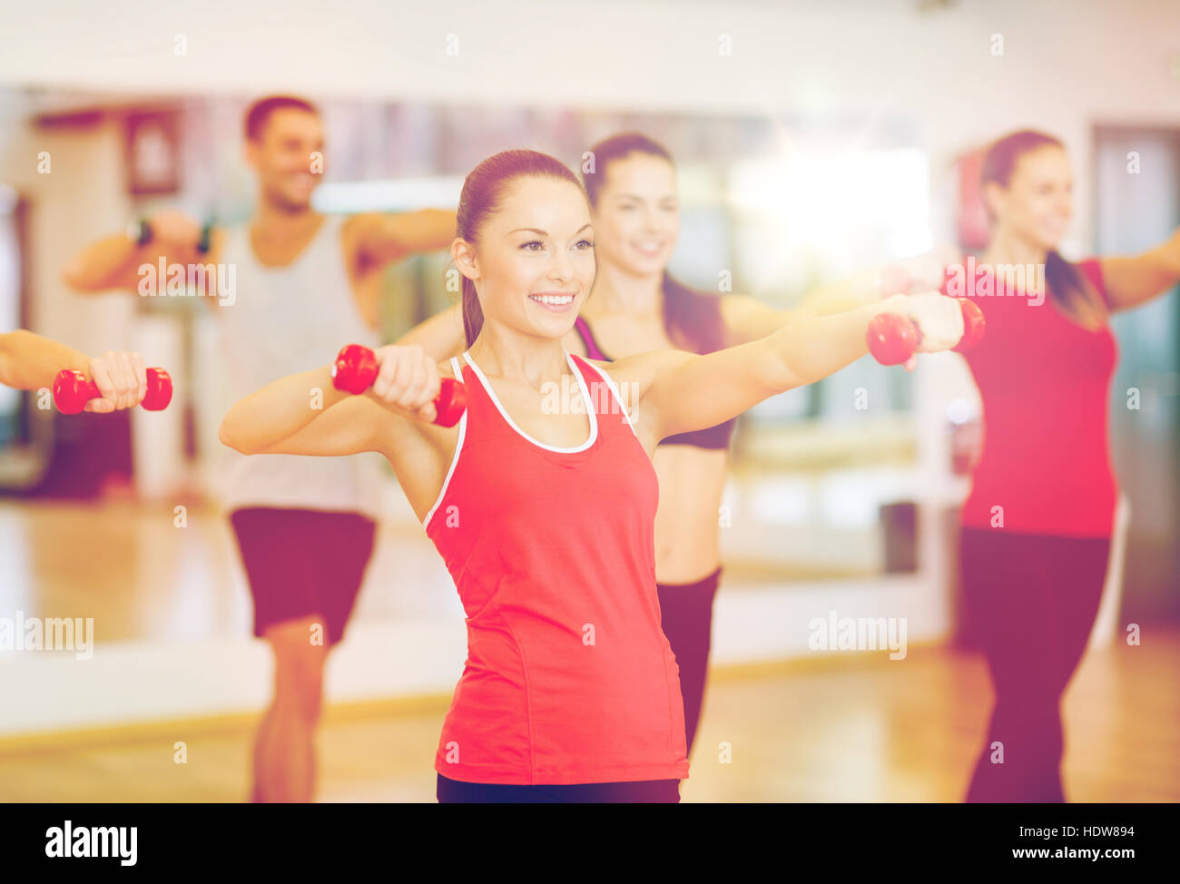 group of smiling people working out with dumbbells Stock Photo - Alamy