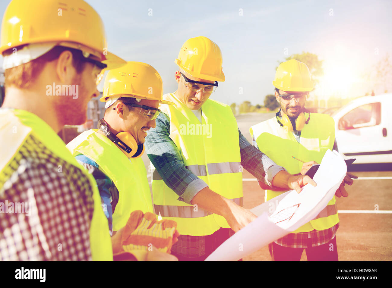group of builders with tablet pc and blueprint Stock Photo - Alamy