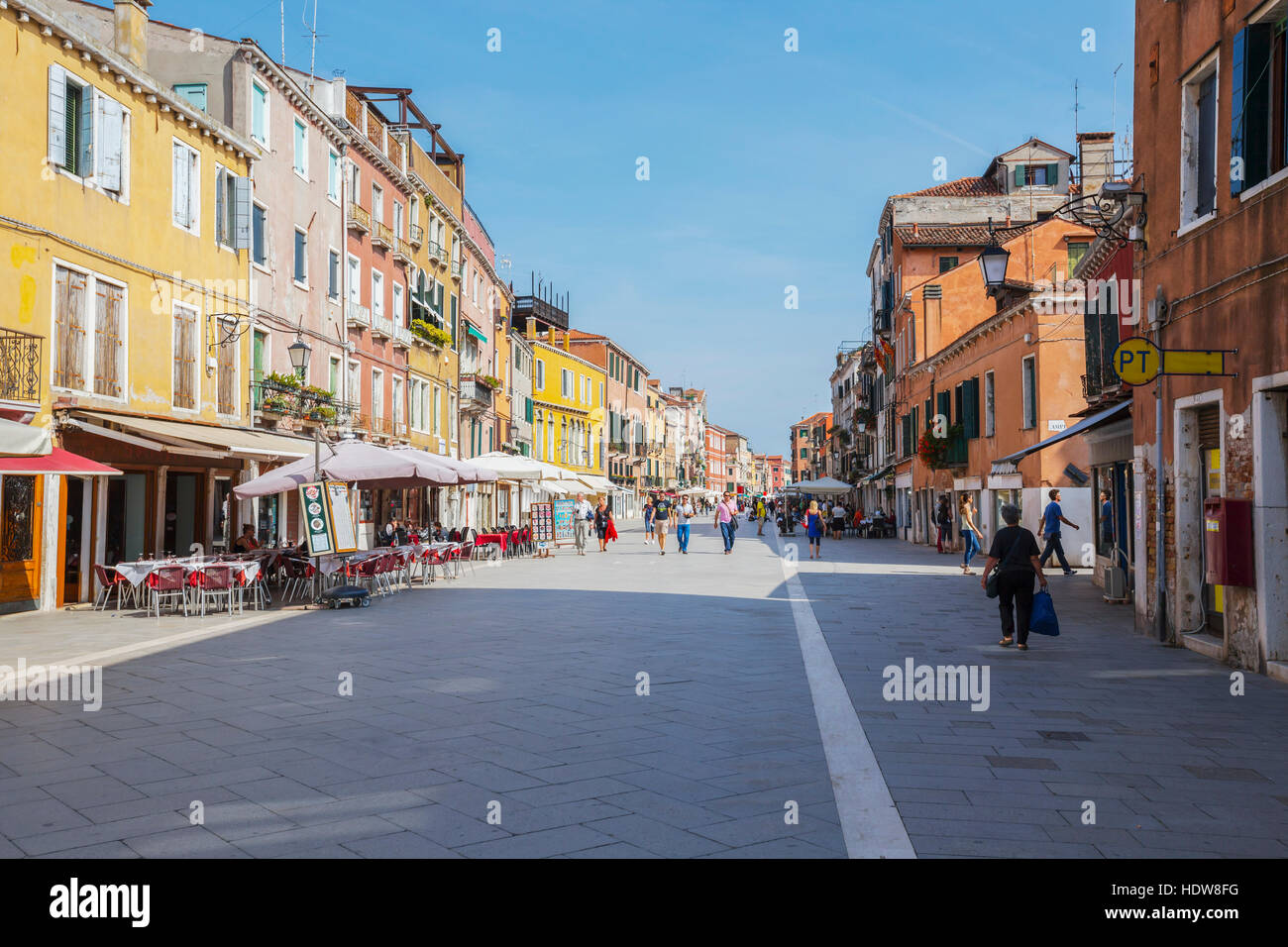 Tourists And Locals Explore One Of The Less Busy Streets In Venice At ...