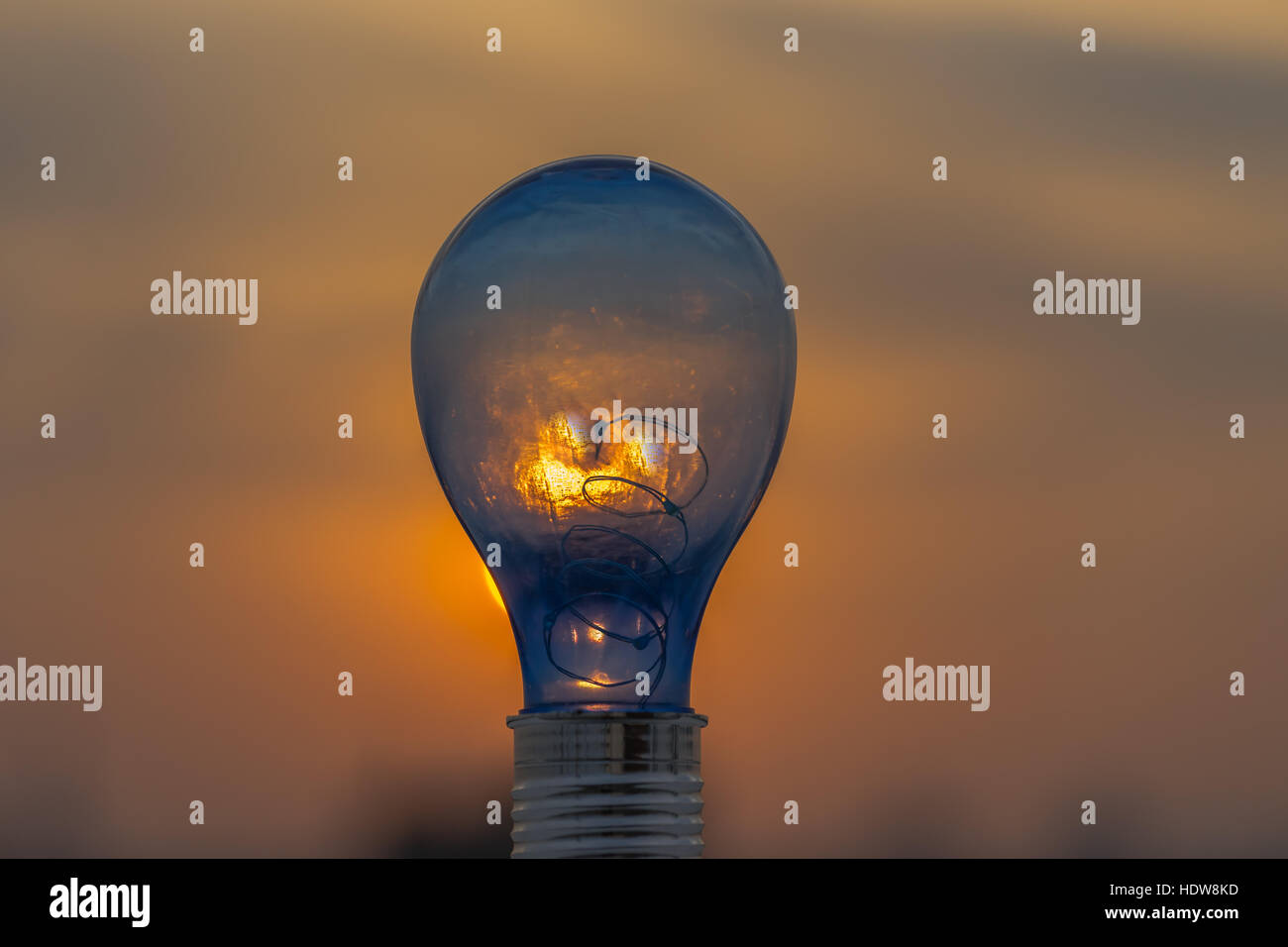 Bright idea, electric light bulb and sunset sky Stock Photo - Alamy