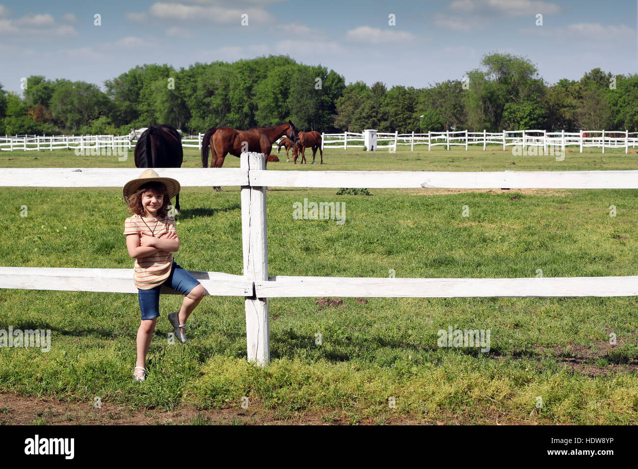 beautiful little girl with cowboy hat on ranch Stock Photo - Alamy