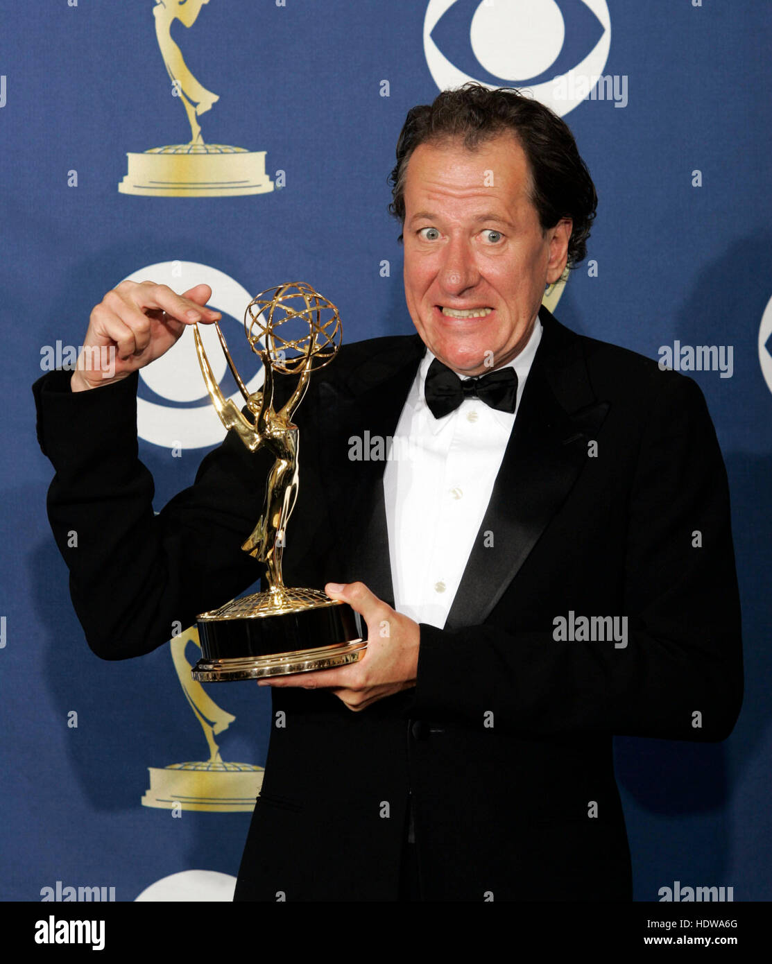 Actor Geoffrey Rush holds his award for outstanding lead actor in a ...
