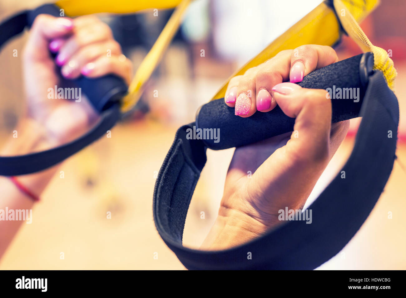 TRX. Female hands with fitness TRX straps in gym Stock Photo - Alamy