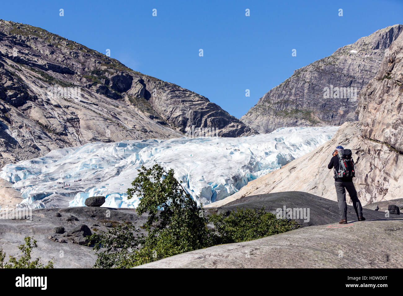 Tourist taking picture in Nigardsbreen glacier, Jostedalsbreen glacier ...
