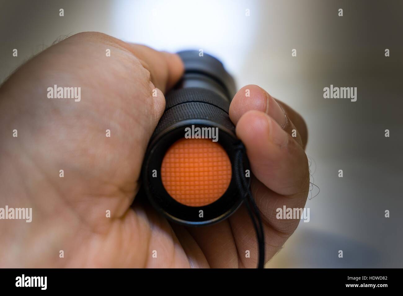 Hand holding turned on flashlight Stock Photo - Alamy