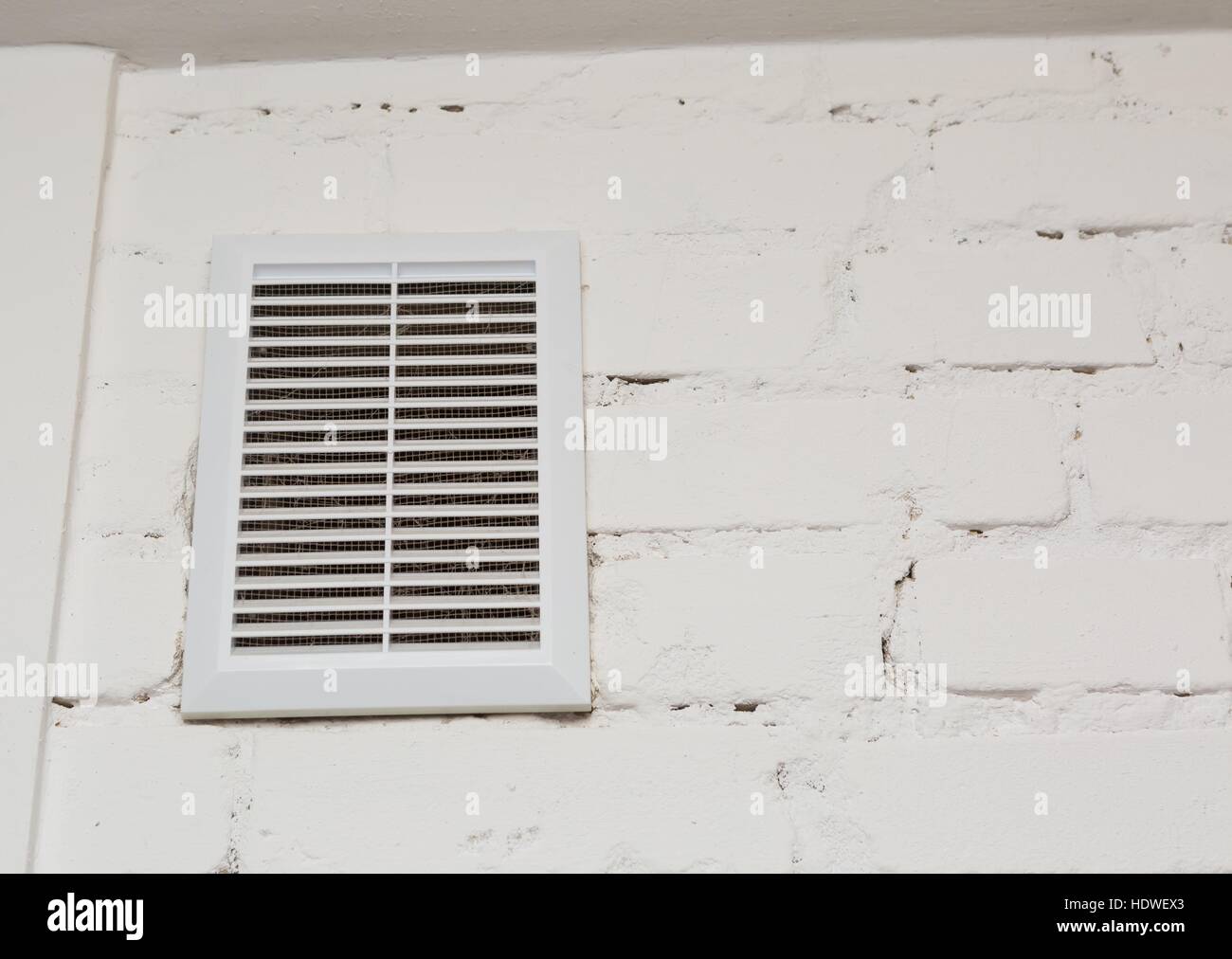 Close up of vent on the white wall. Plastic ventilation grid, piece of ...