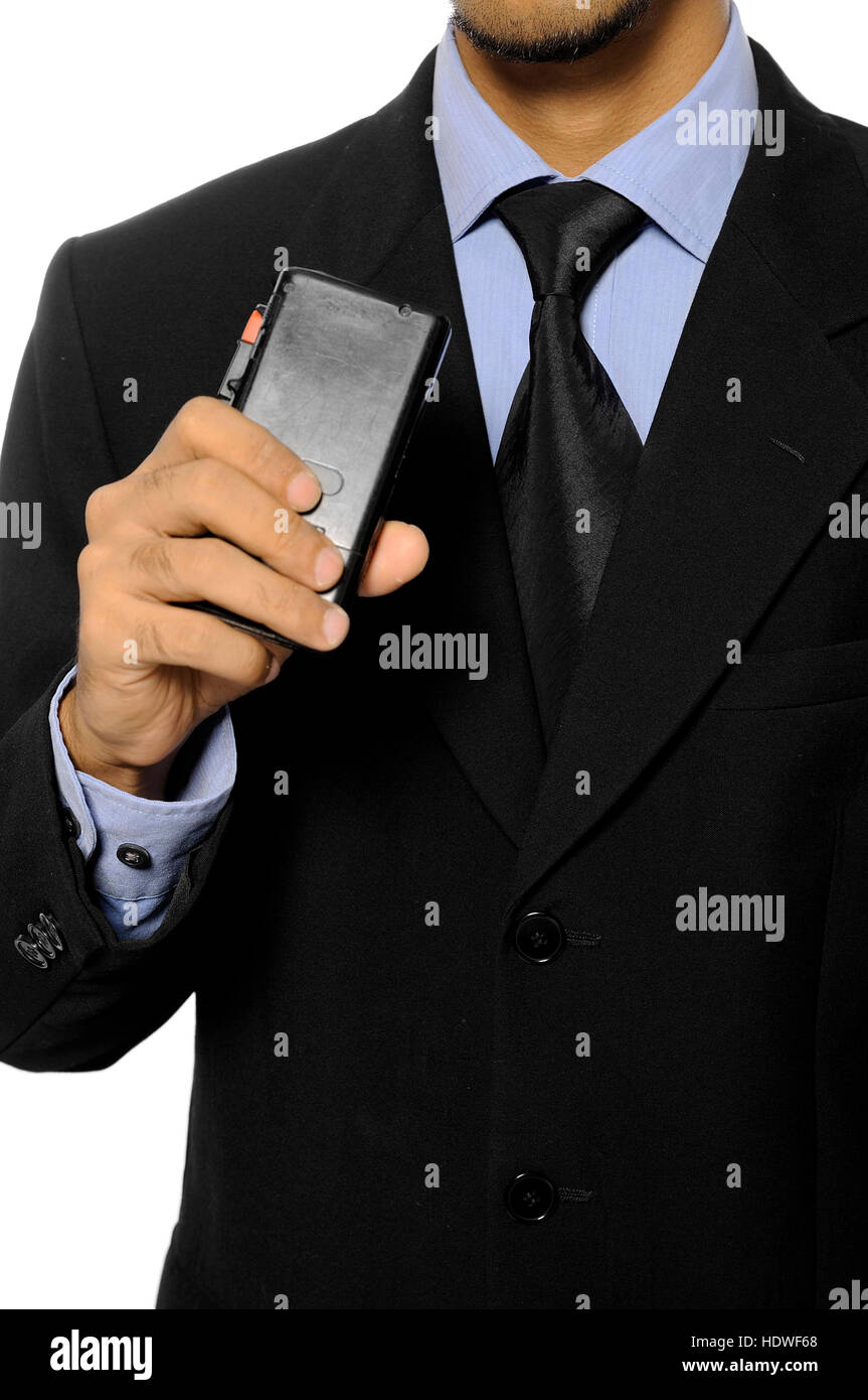 Businessman speaking into a dictaphone recorder isolated over white ...