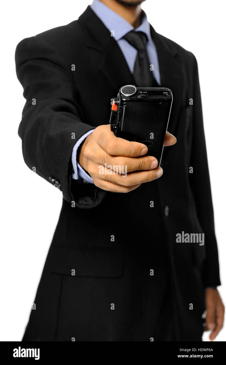 Businessman speaking into a dictaphone recorder isolated over white ...