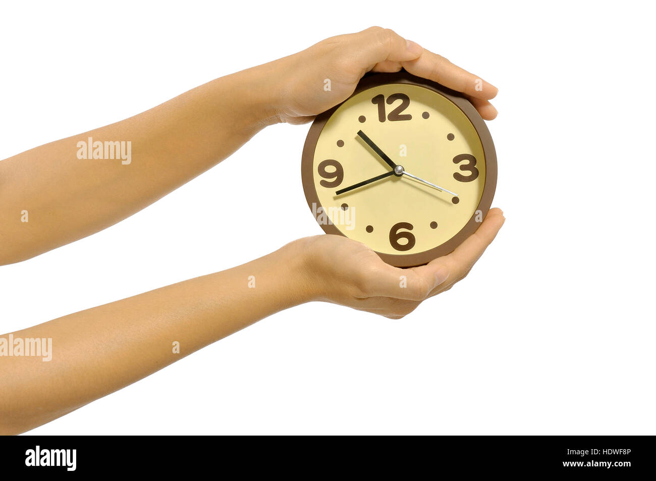 Hand holding clock isolated over white background. Overtime concept ...