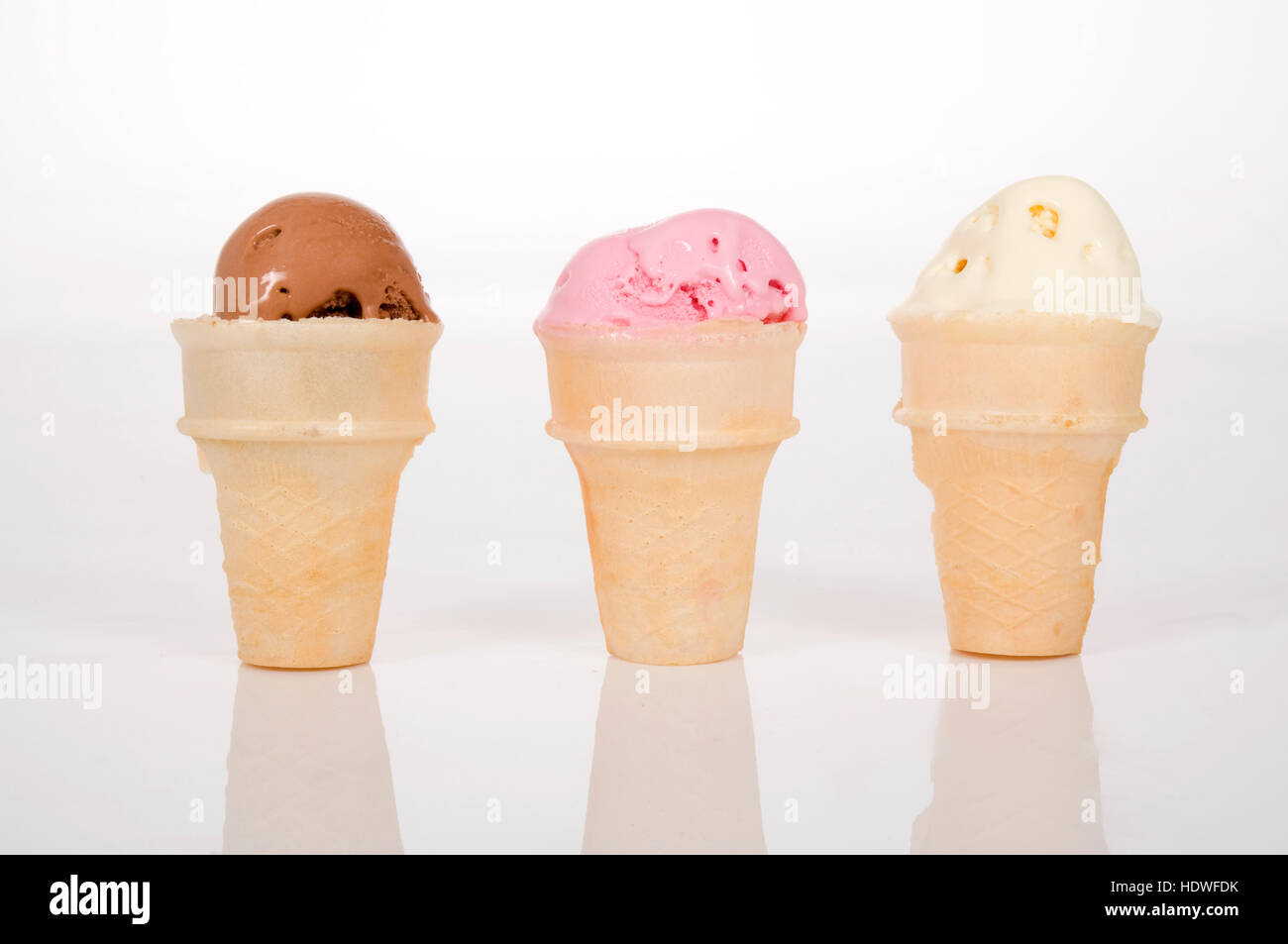 Three scoops of ice creams on white background Stock Photo - Alamy