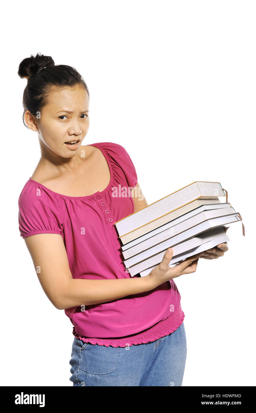 Asian college student carrying stack of books isolated over white ...