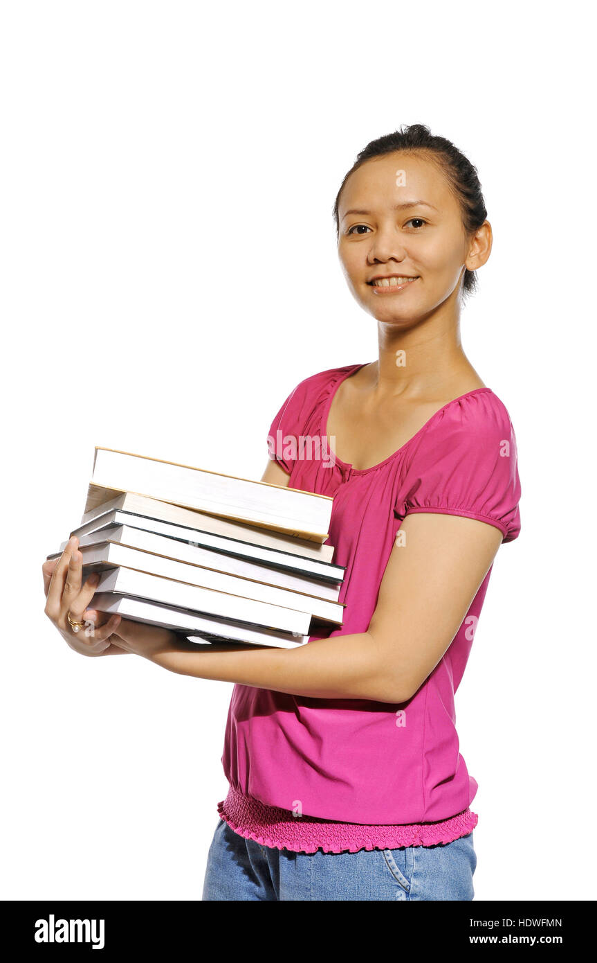 Asian college student carrying stack of books isolated over white ...