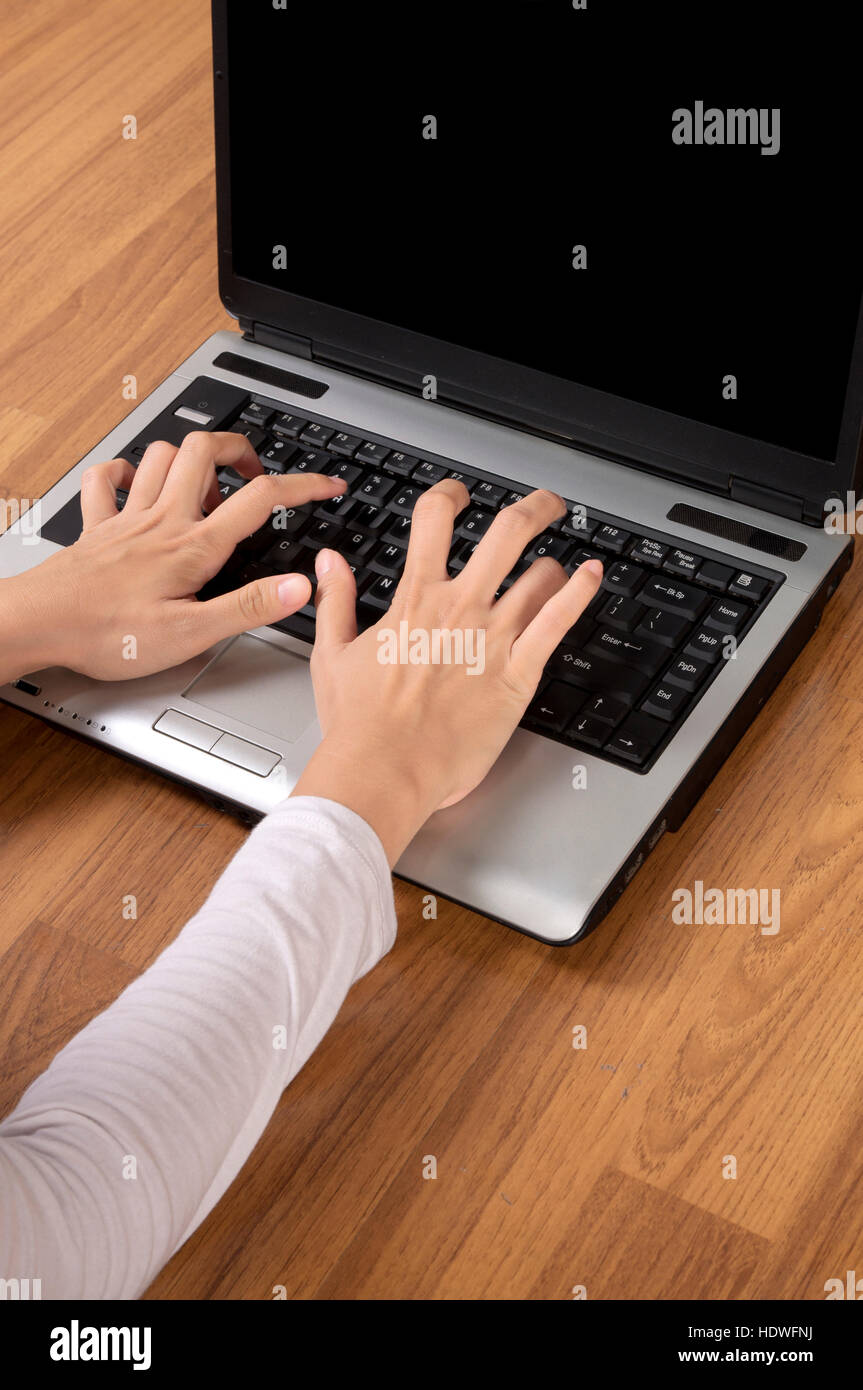 Woman hand writing with laptop computer on the wooden floor Stock Photo ...