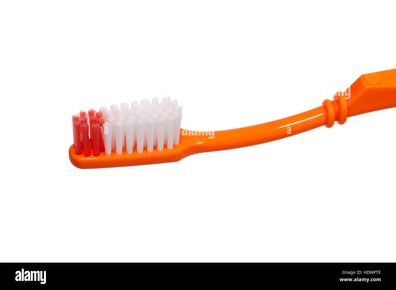Orange colored toothbrush isolated on white background Stock Photo - Alamy