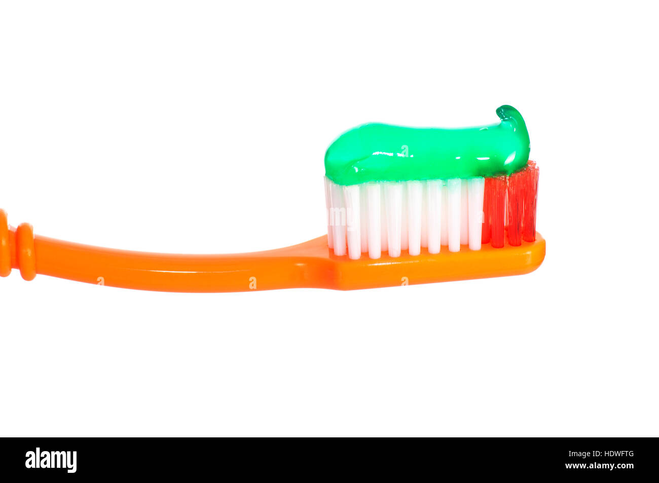 Orange colored toothbrush isolated on white background Stock Photo - Alamy