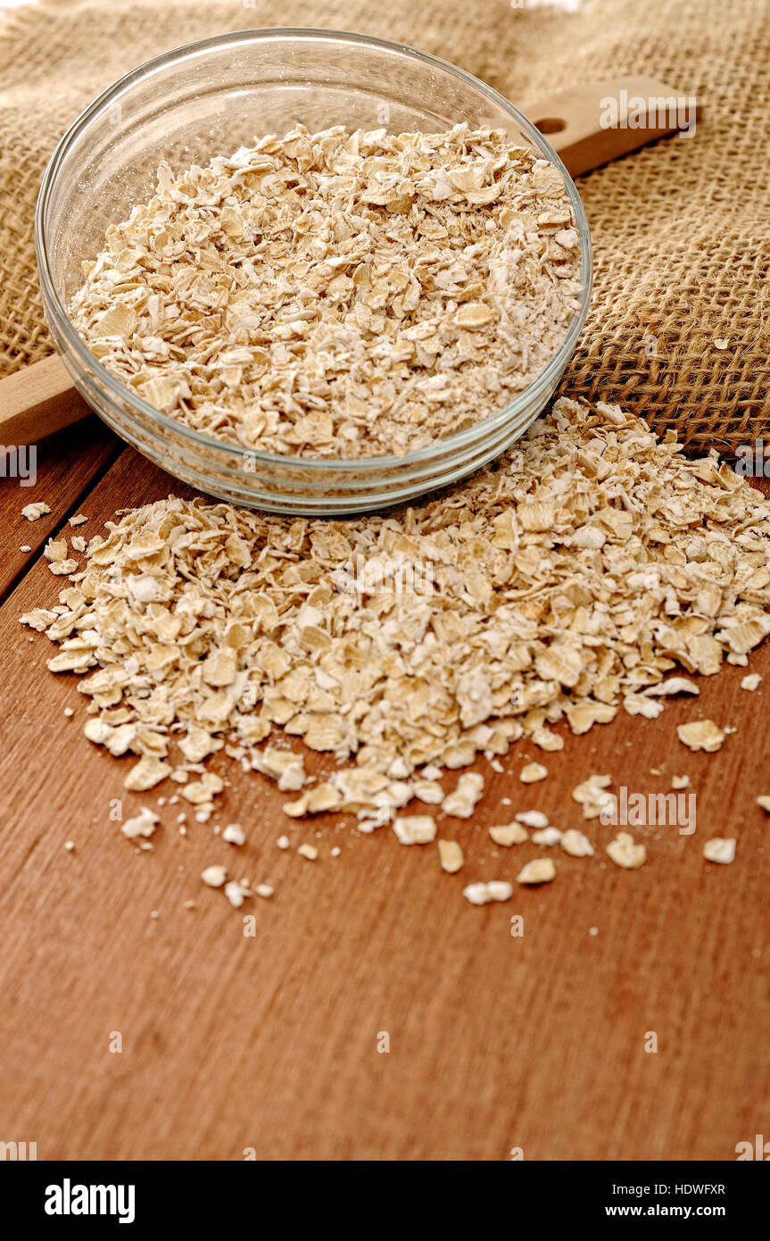 Oatmeal in glass bowl. Shot with wooden background and burlap Stock ...