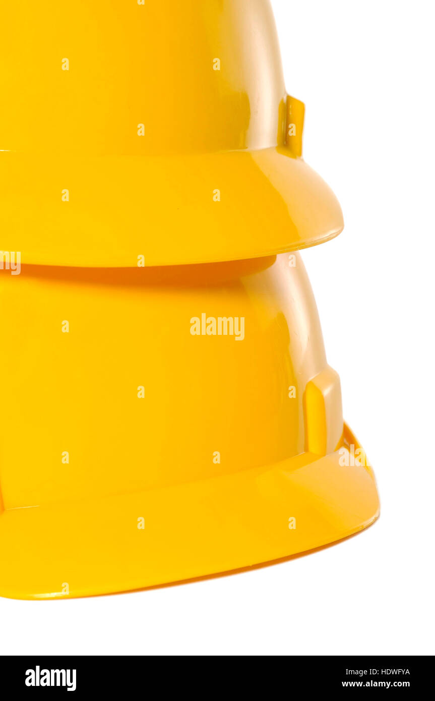 Two yellow construction helmet isolated over white background Stock ...