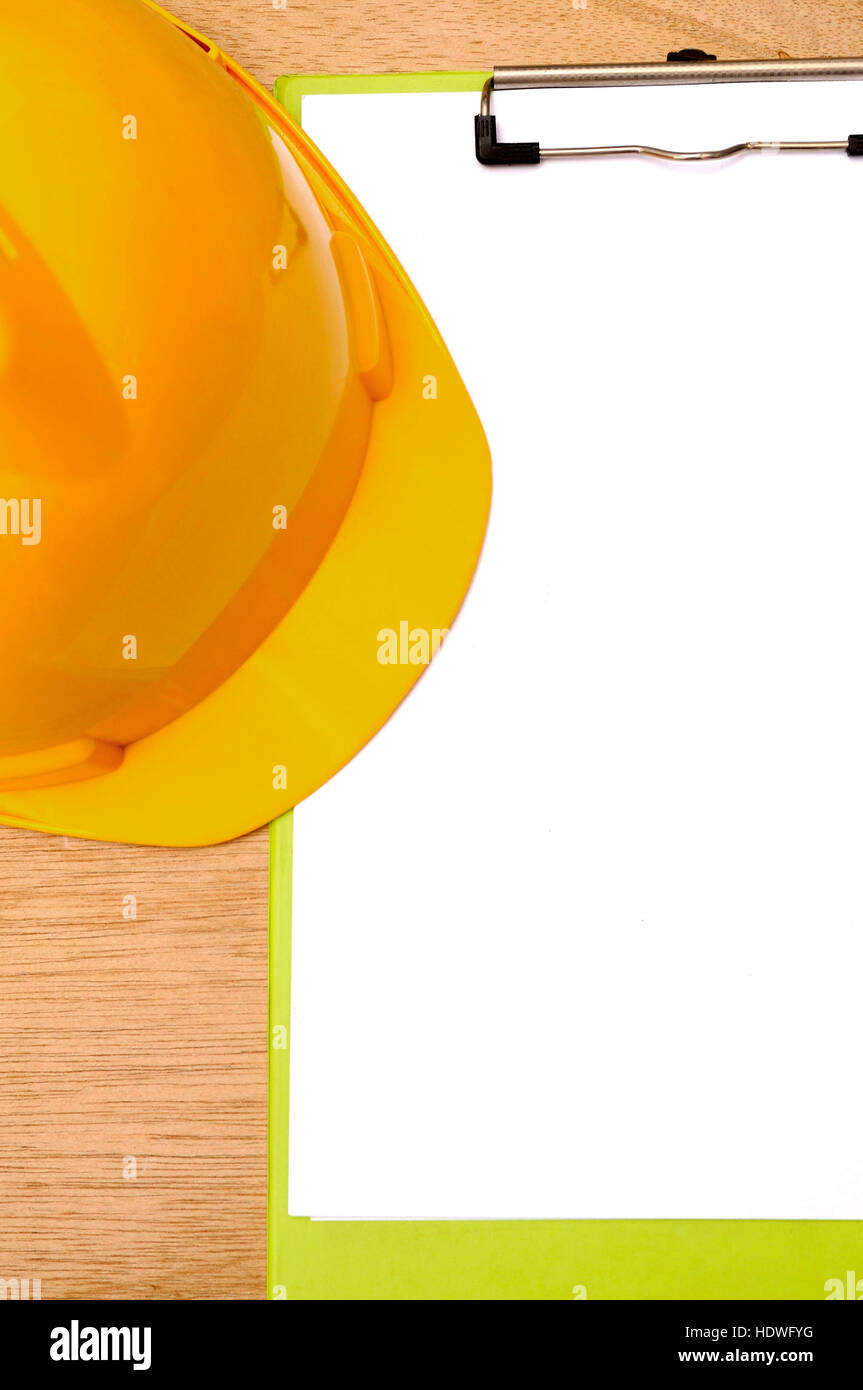 Yellow hard hat and clipboard. You can put your design on the clipboard ...