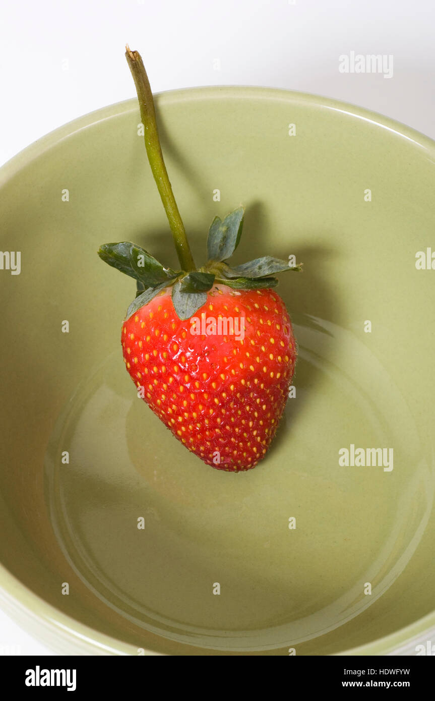 Strawberry shot inside the bowl. Over white background Stock Photo - Alamy
