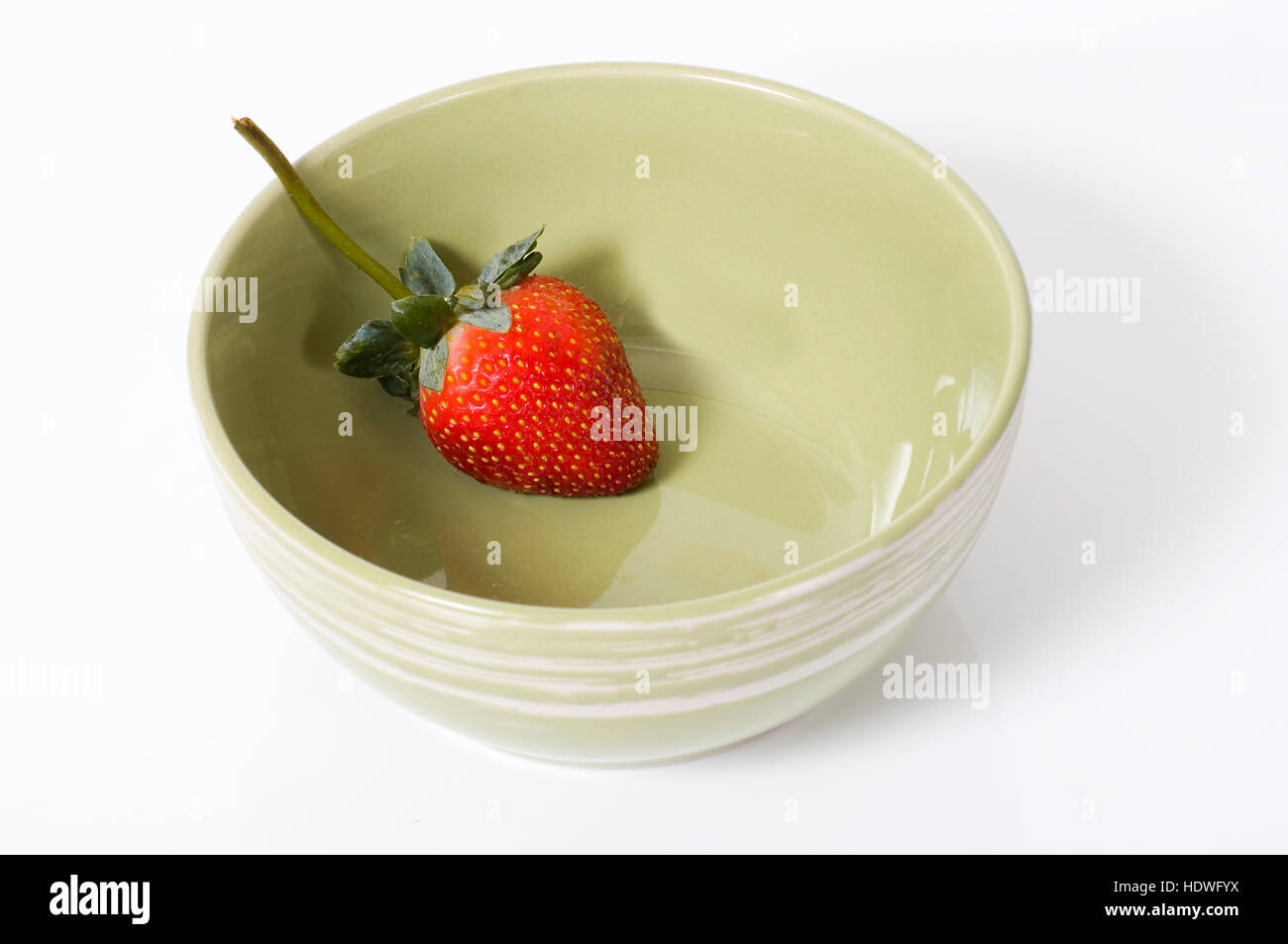 Strawberry shot inside the bowl. Over white background Stock Photo - Alamy
