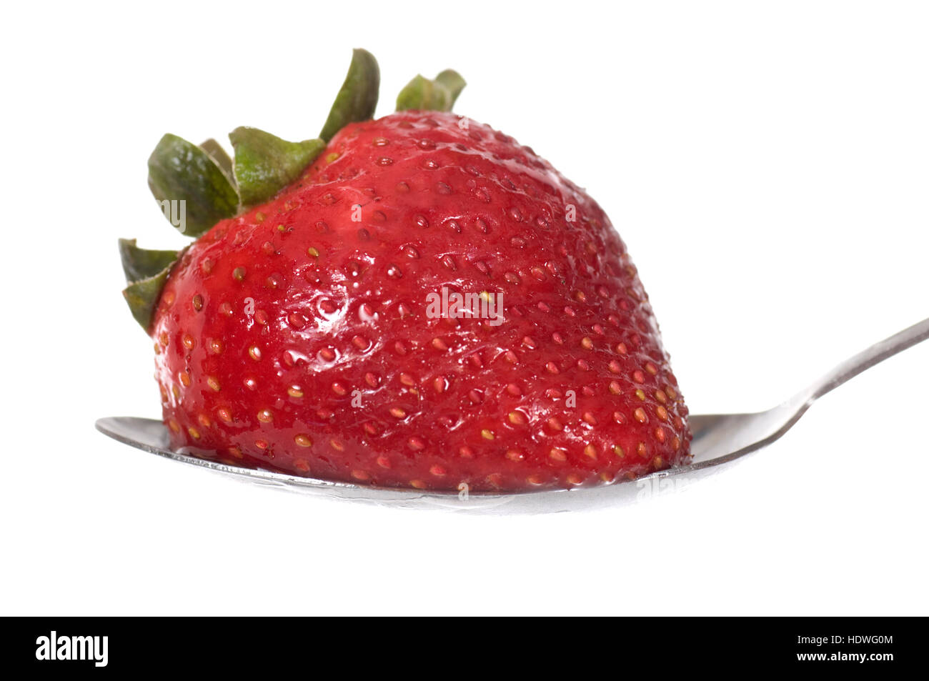 Strawberry on the spoon isolated over white background Stock Photo - Alamy