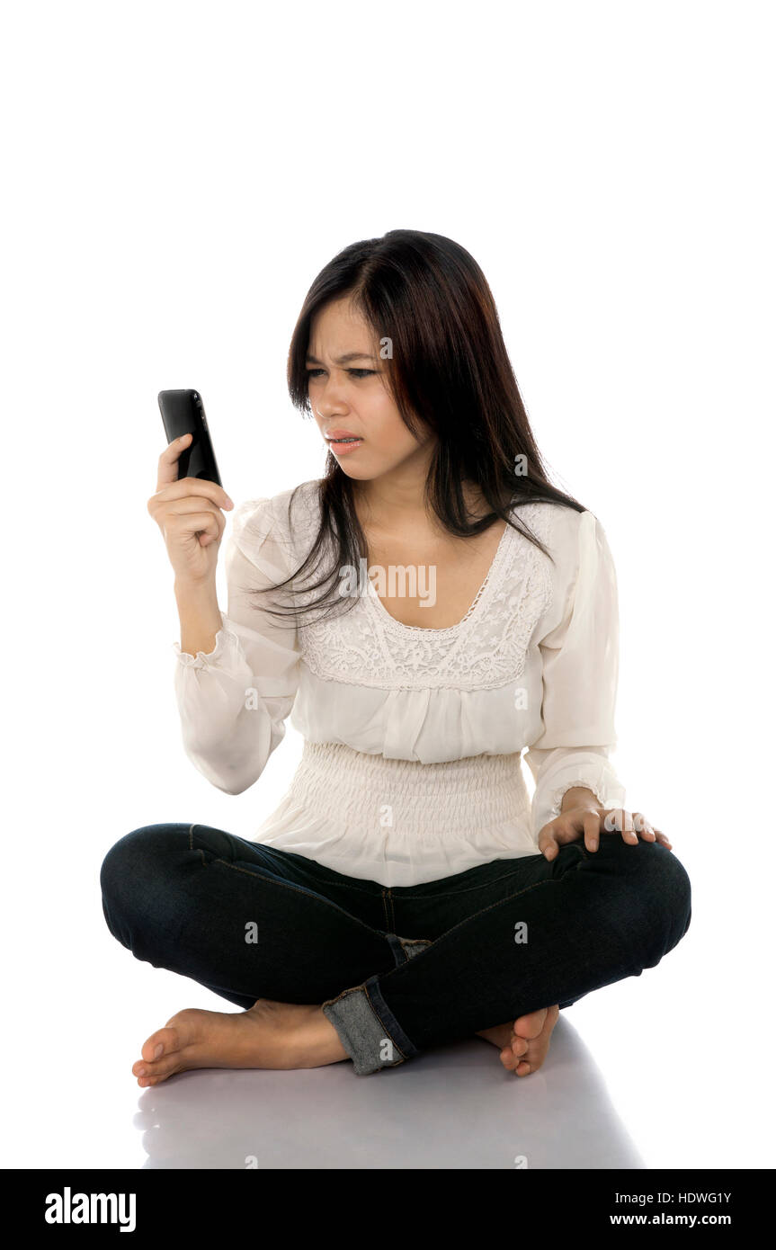 Asian woman shock see news on the cellphone, isolated on white ...