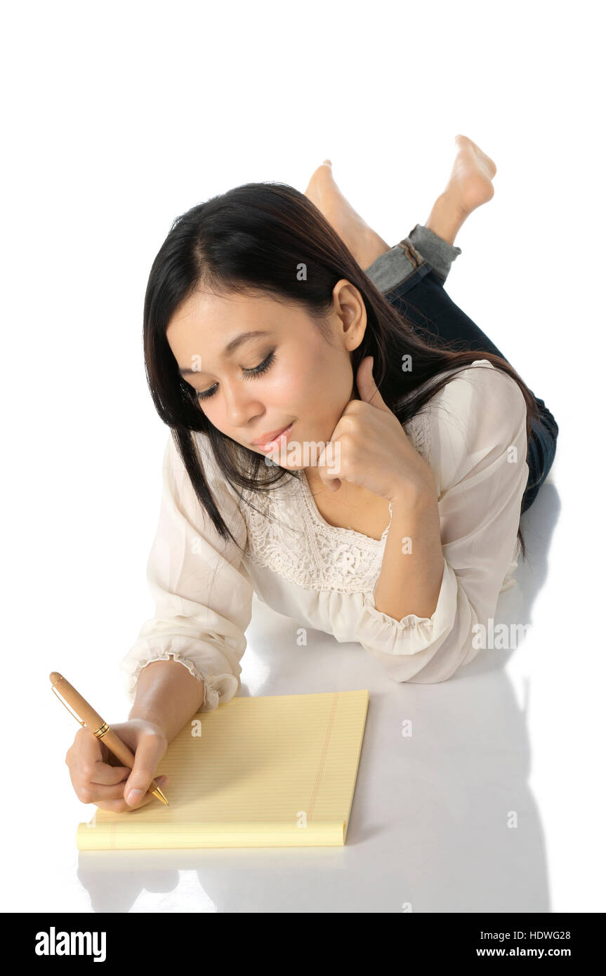 Pretty asian woman write on the floor, isolated over white background ...