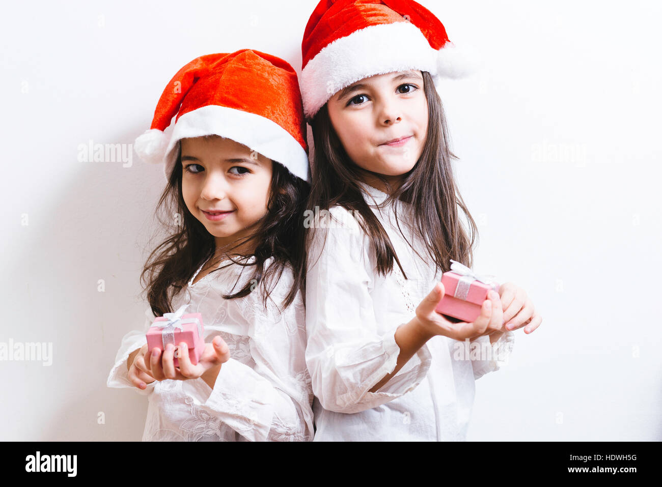Two girls posing for Christmas and New Year holidays Stock Photo - Alamy