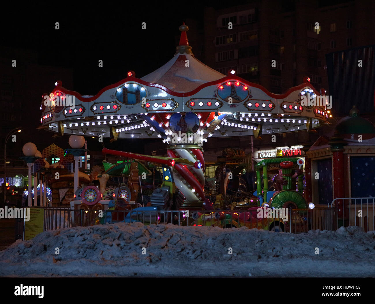Swing carousel ride in amusement park at night Stock Photo - Alamy