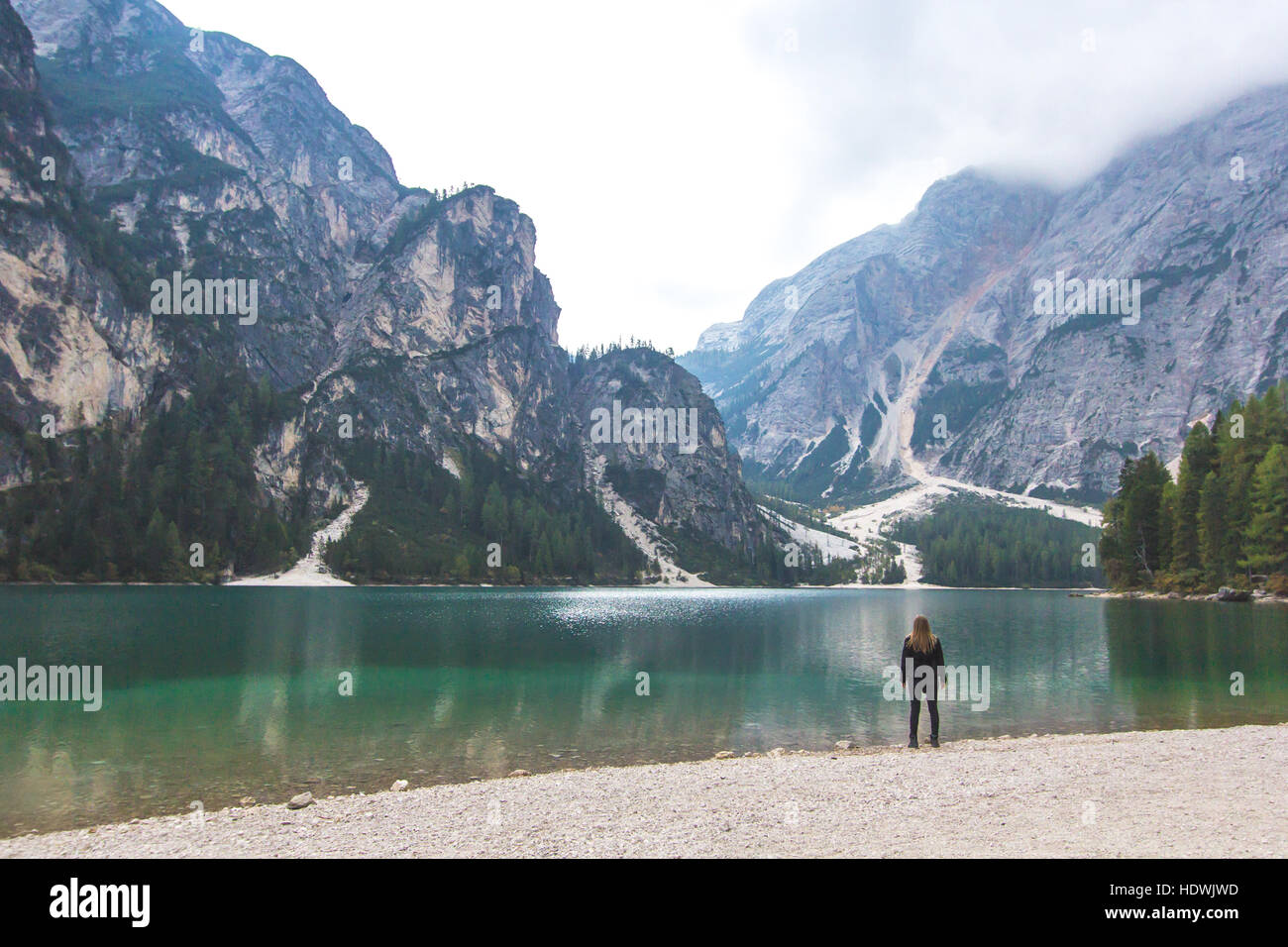 Young woman looking out at Lago di Braies Stock Photo - Alamy