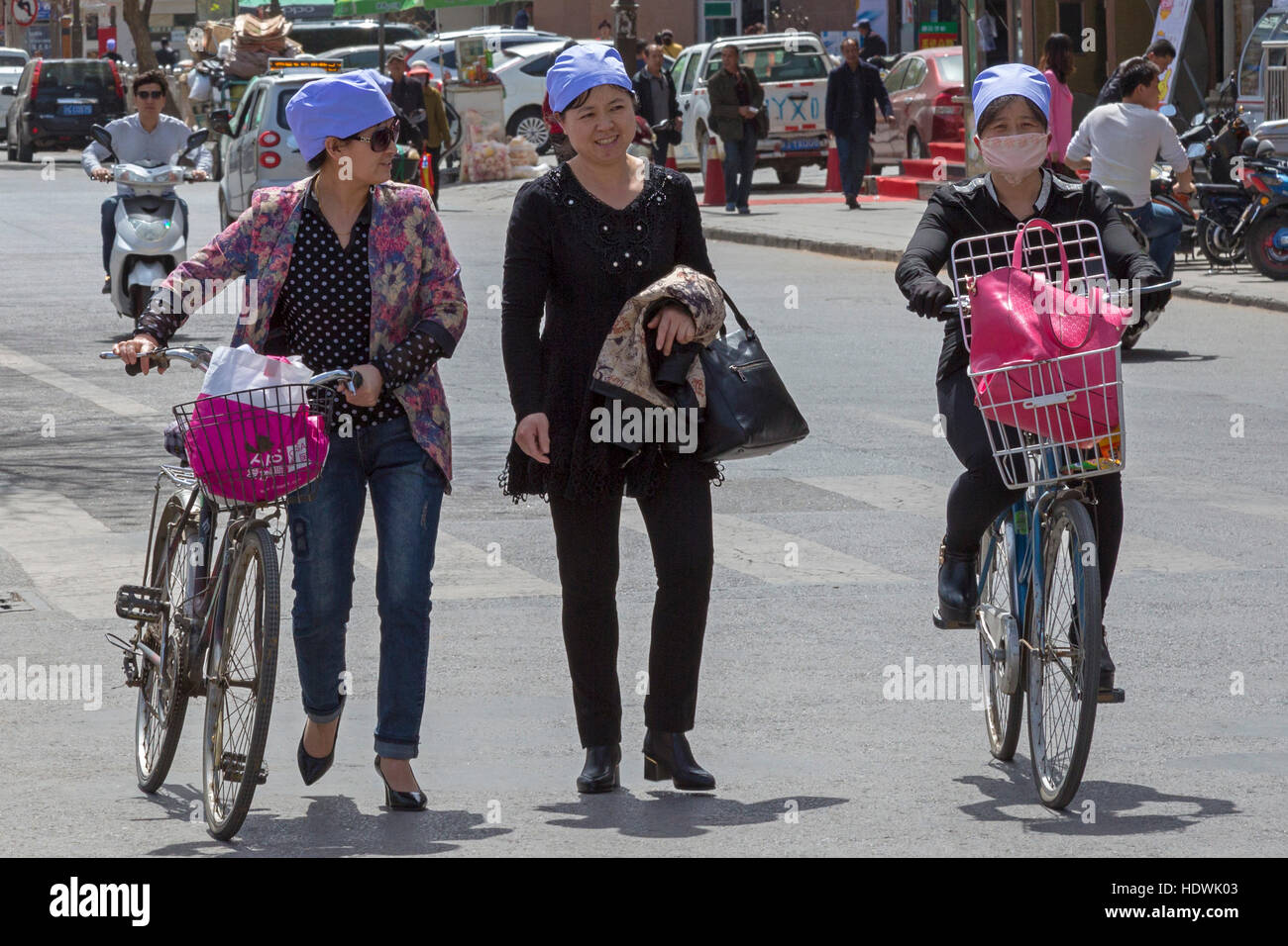 Hui women pushing bicycles, Wuzhong, Ningxia, China Stock Photo - Alamy