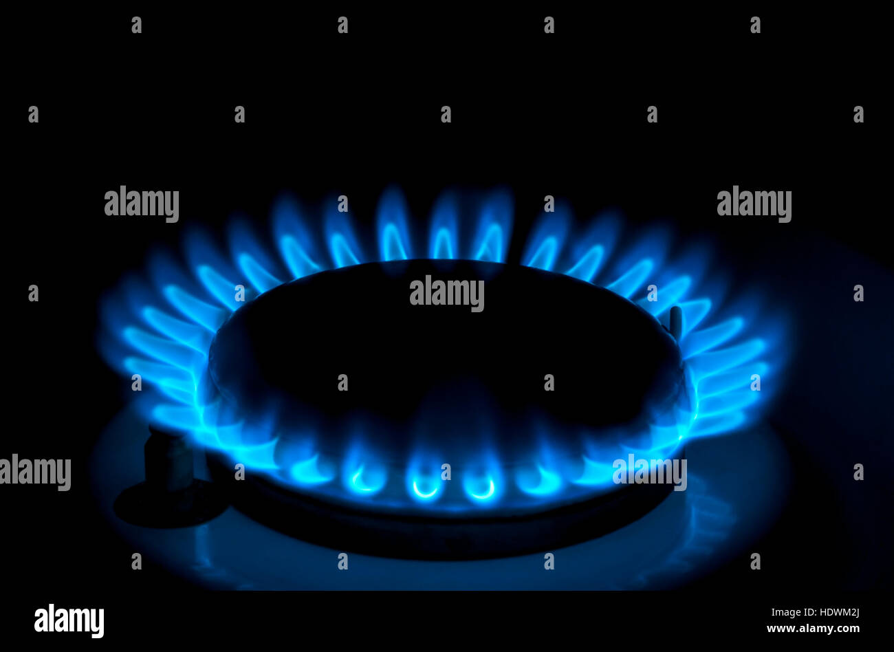 Natural gas burning a blue flames on black background Stock Photo - Alamy