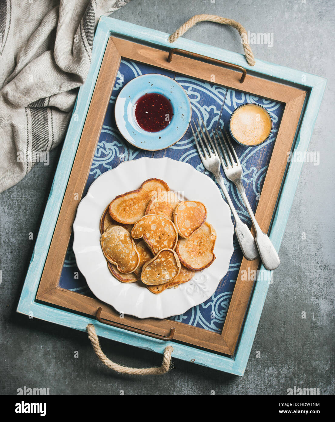 Breakfast tray with whole grain pancakes, raspberry jam, coffee ...