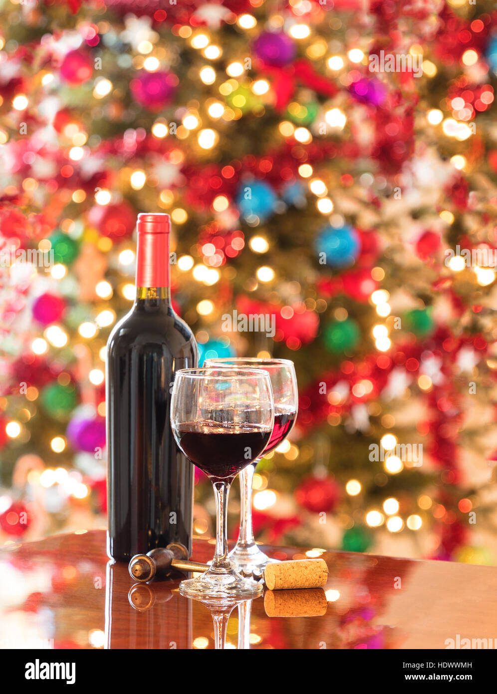 Red wine on Mahoney table for holiday celebration Stock Photo - Alamy