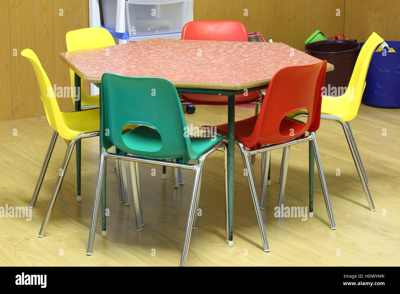 Hexagonal table with small chairs in elementary school with parquet ...