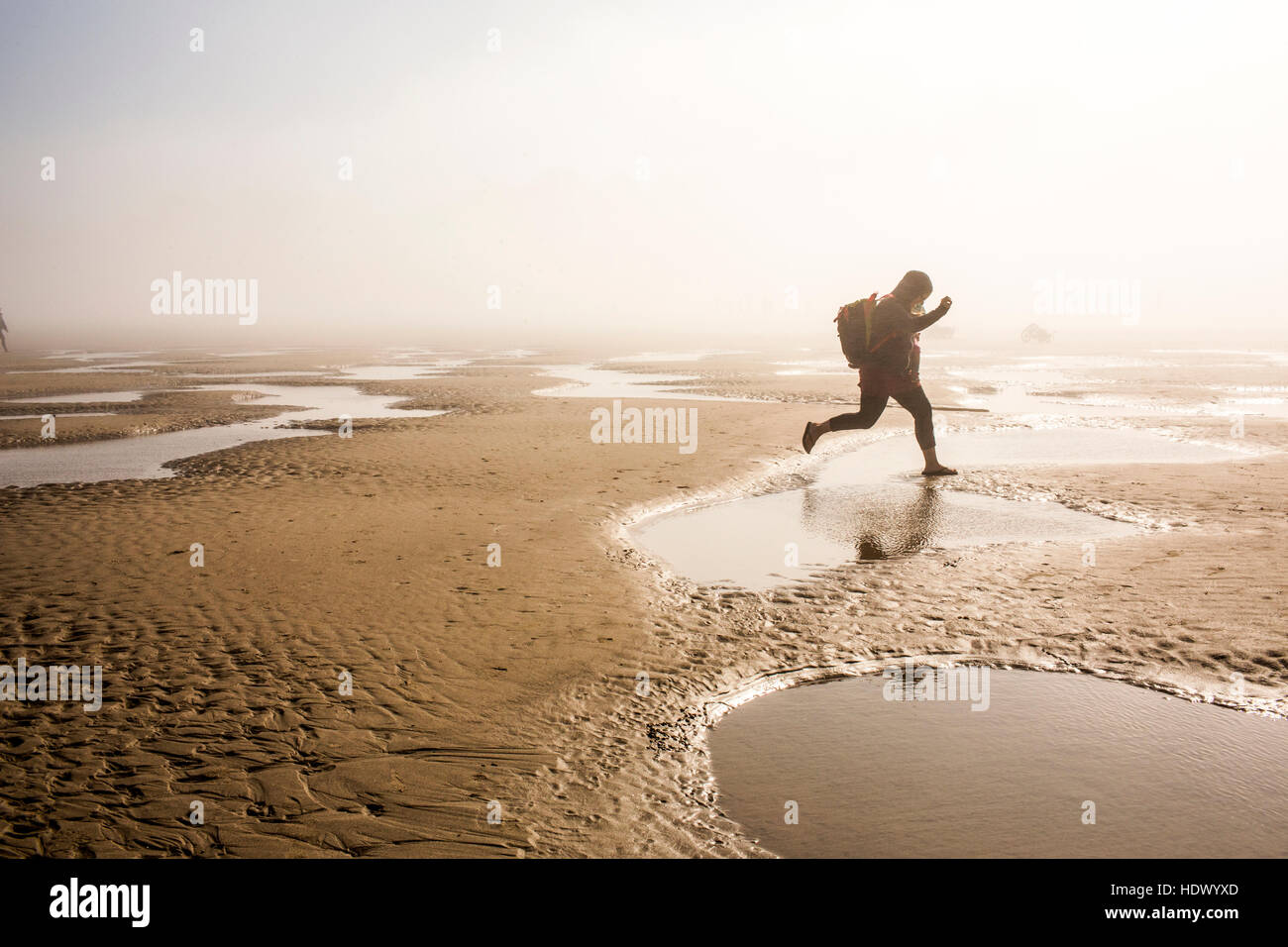 Woman jumping over puddle hi-res stock photography and images - Alamy