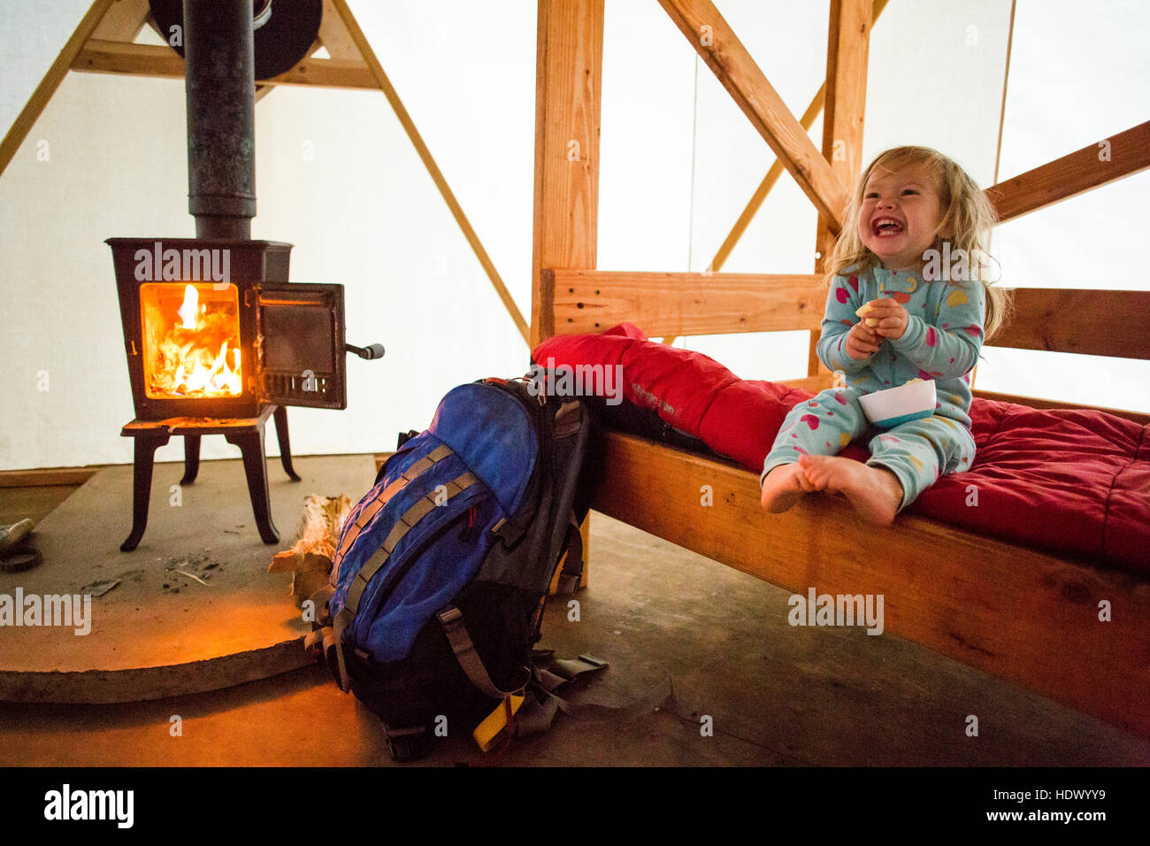 Caucasian girl laughing on bed in yurt Stock Photo - Alamy
