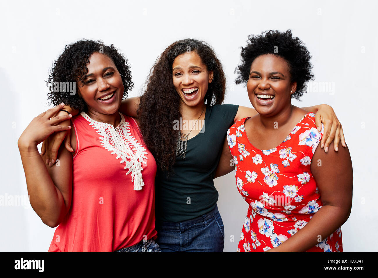 Portrait of smiling friends hugging Stock Photo - Alamy