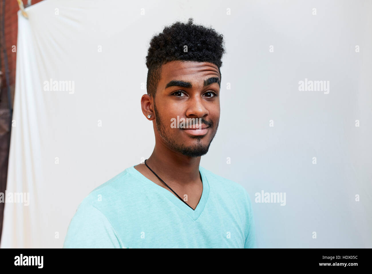 Portrait of smiling Black man raising eyebrow Stock Photo - Alamy