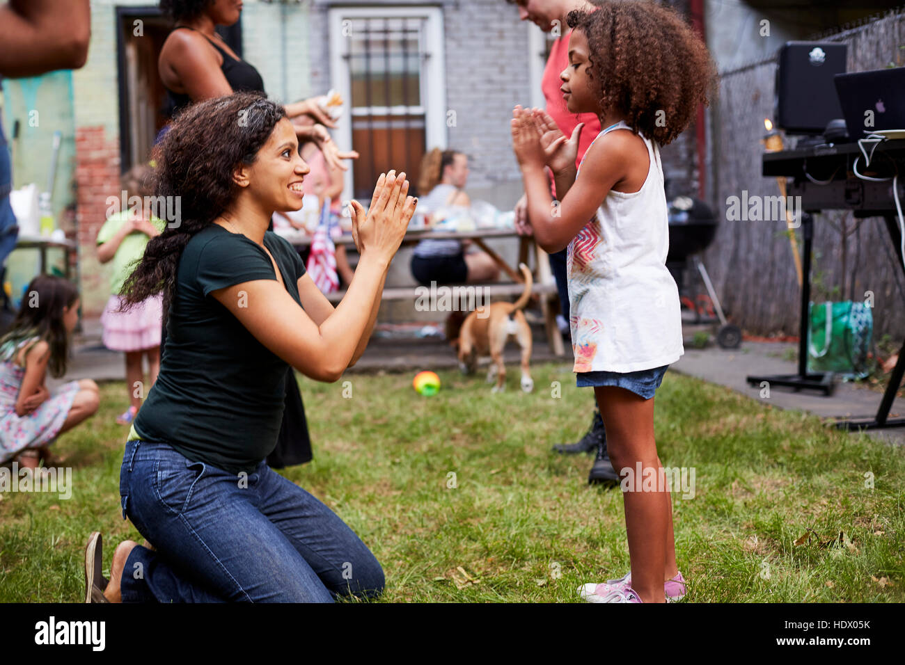 Mixed Race mother and daughter playing clapping game Stock Photo - Alamy