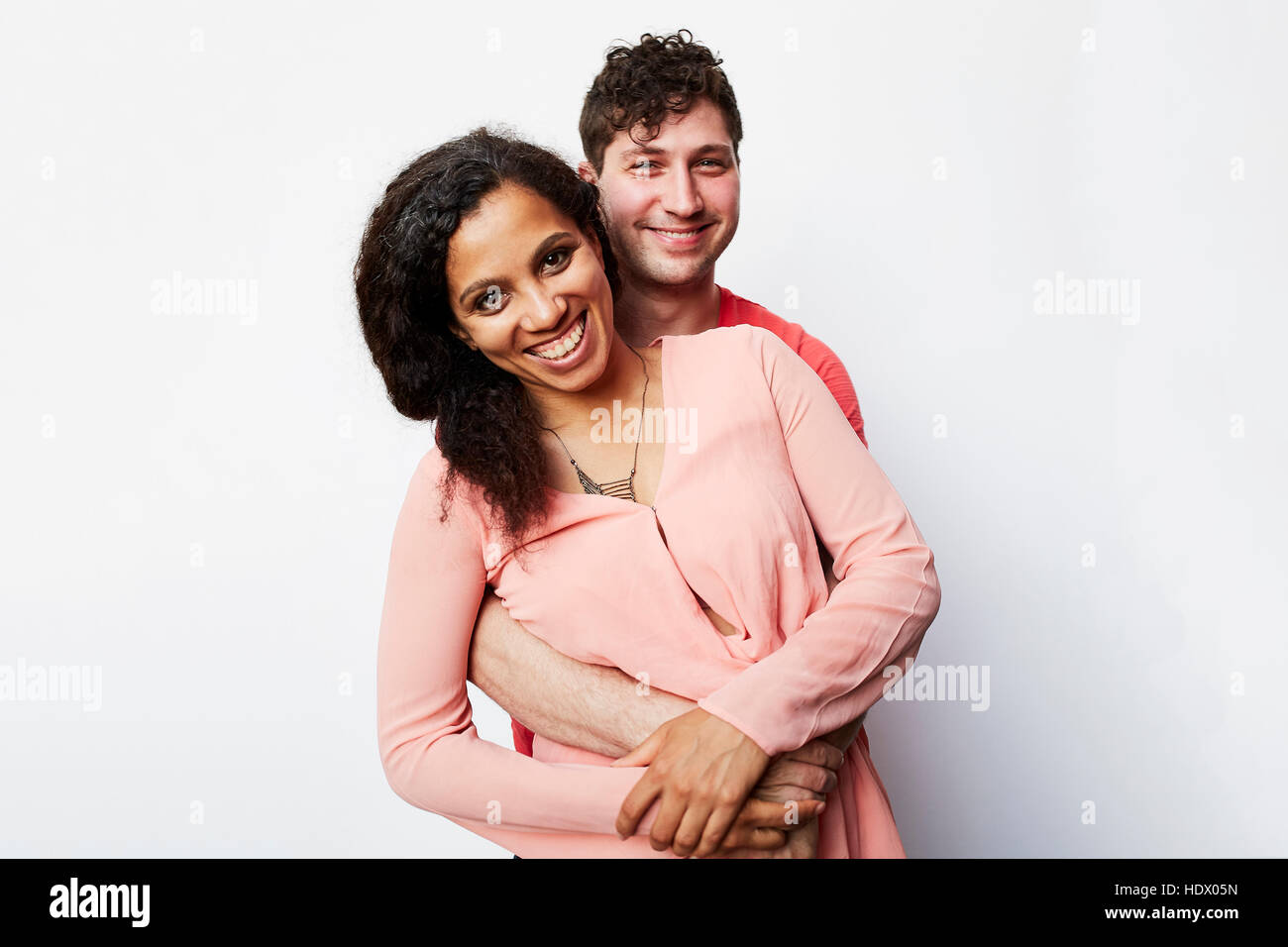 Portrait of smiling couple hugging Stock Photo - Alamy