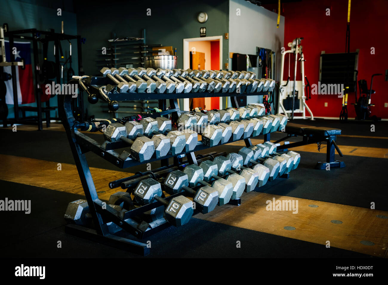 Dumbbells on rack in gymnasium Stock Photo - Alamy