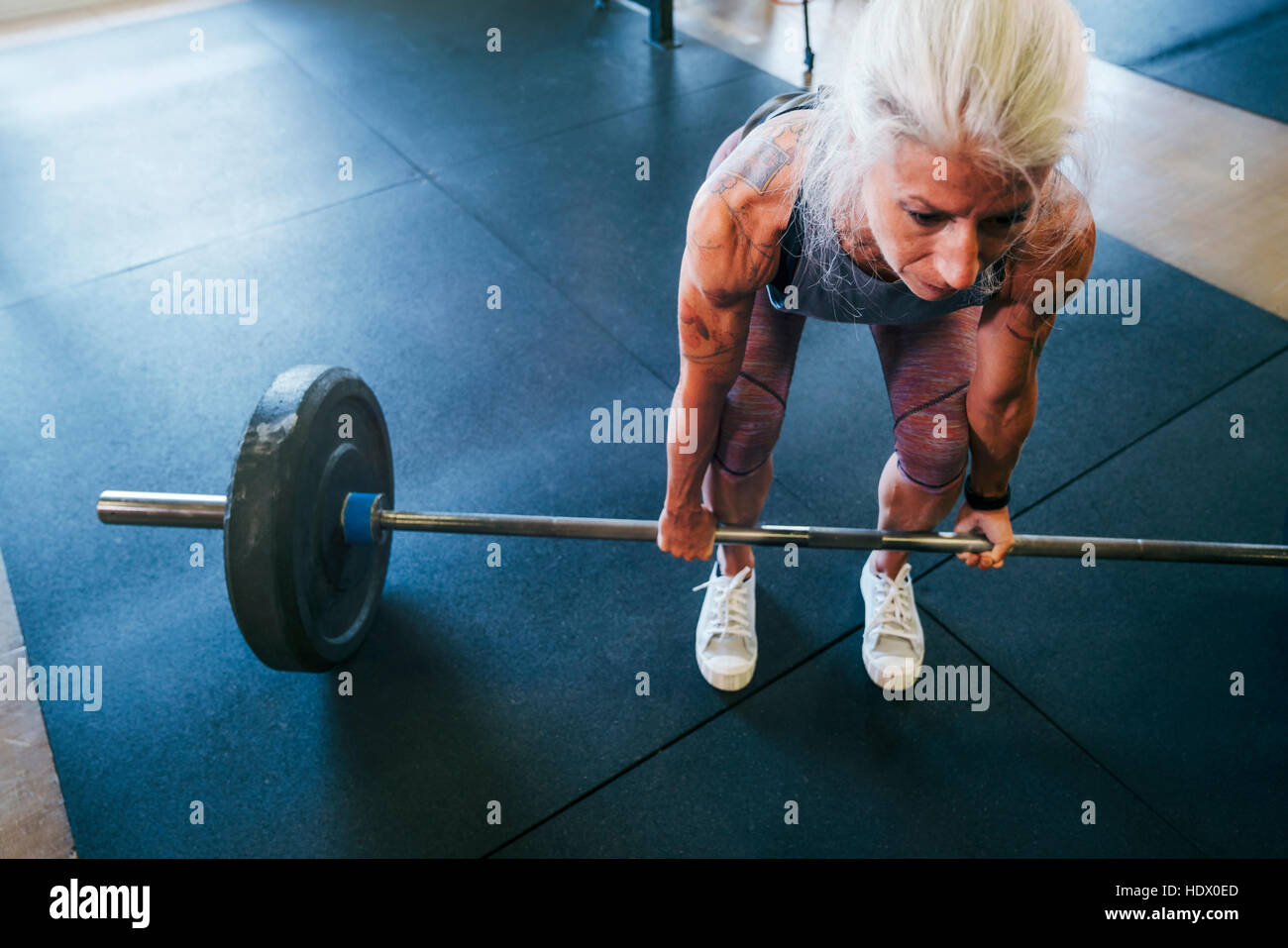 Caucasian women lifting barbell in gymnasium Stock Photo - Alamy