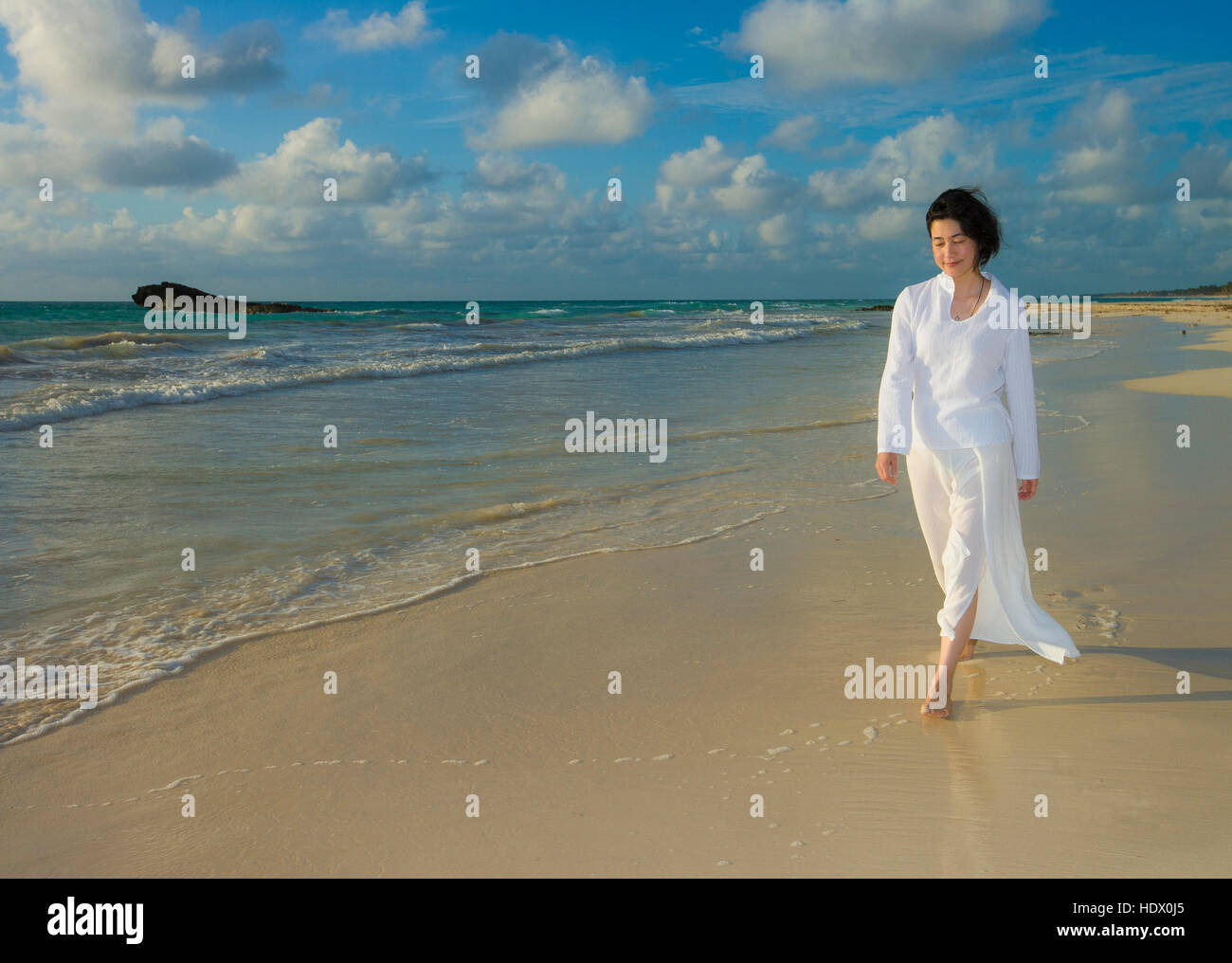 Japanese woman walking on beach Stock Photo - Alamy