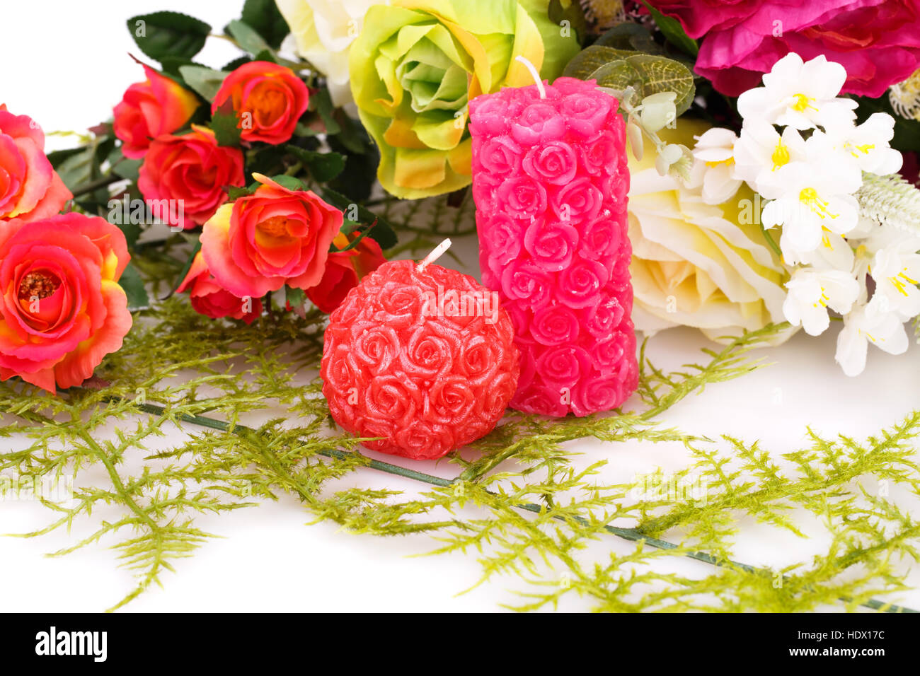 Colorful roses and candles on white background Stock Photo - Alamy