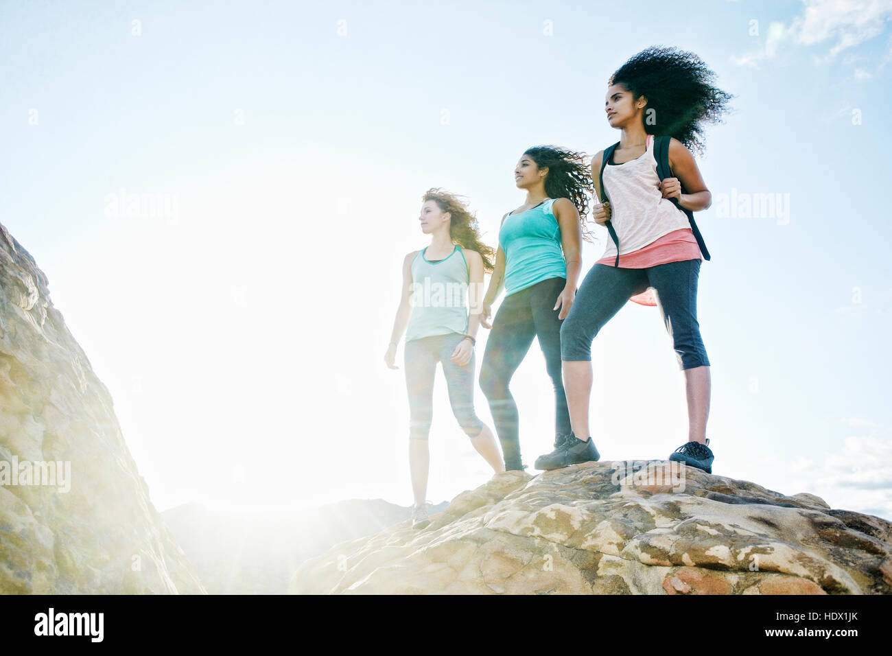 Women standing on rock Stock Photo - Alamy