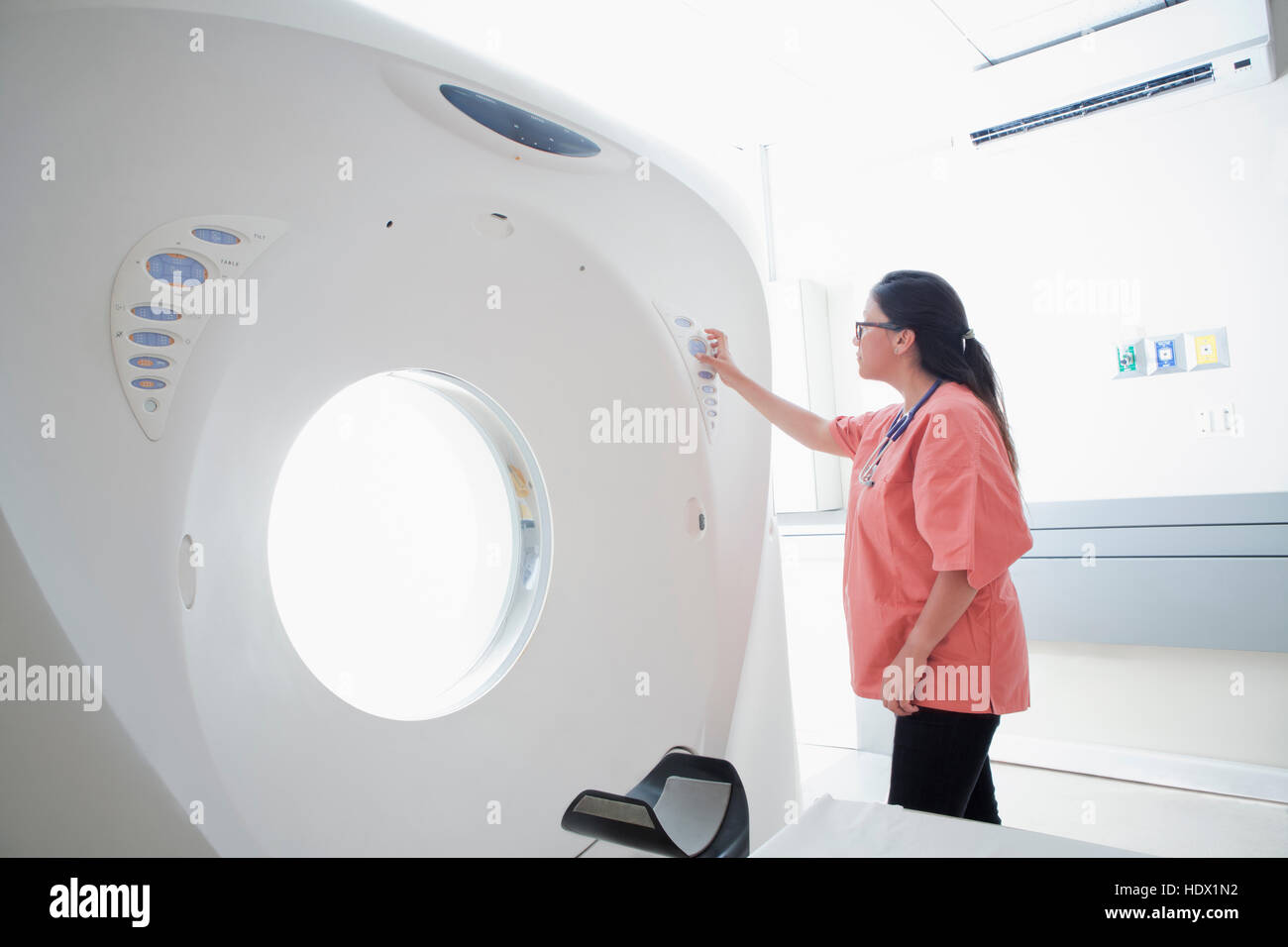 Hispanic nurse checking scanner Stock Photo - Alamy