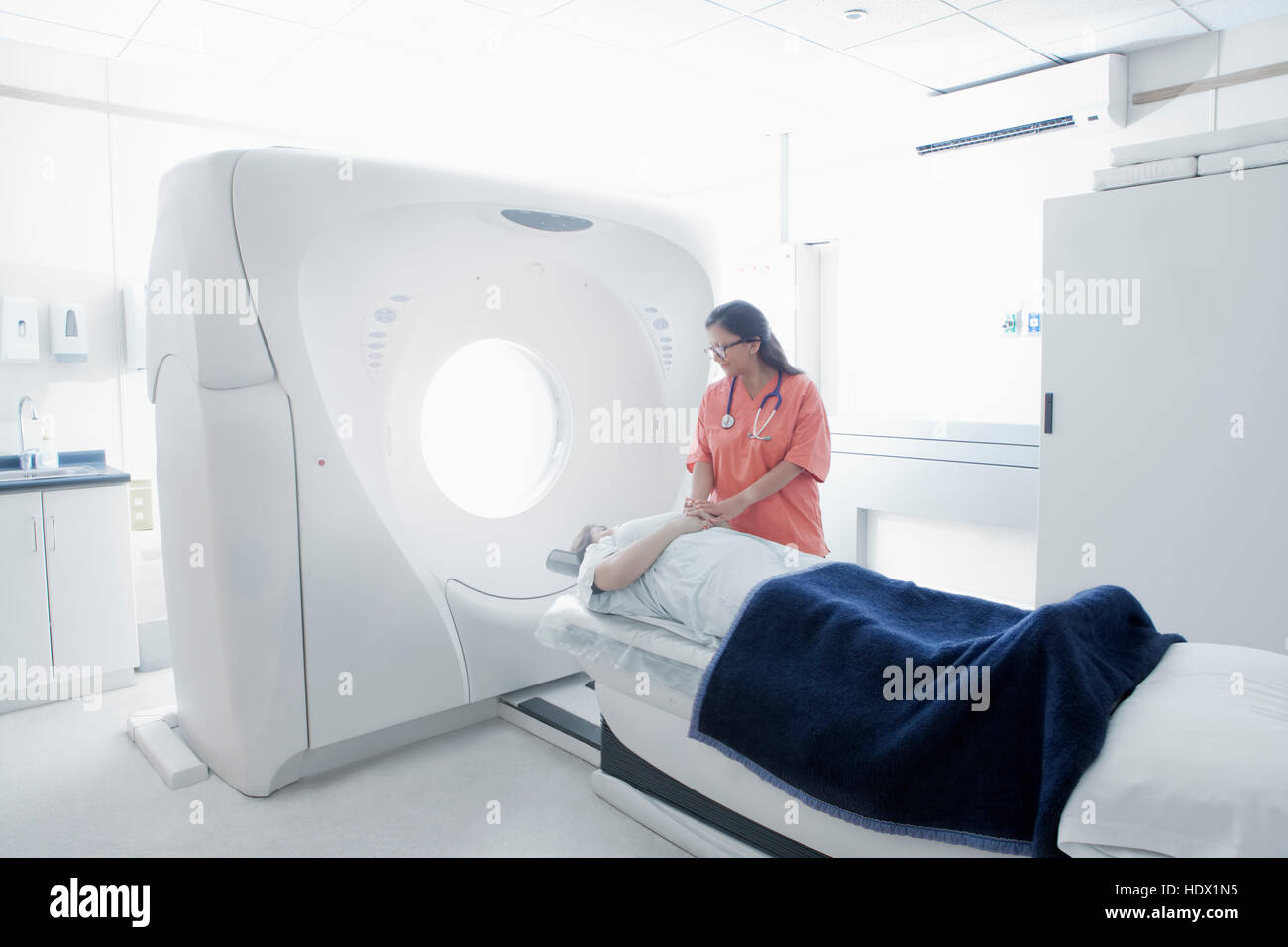 Hispanic nurse comforting patient at scanner Stock Photo - Alamy