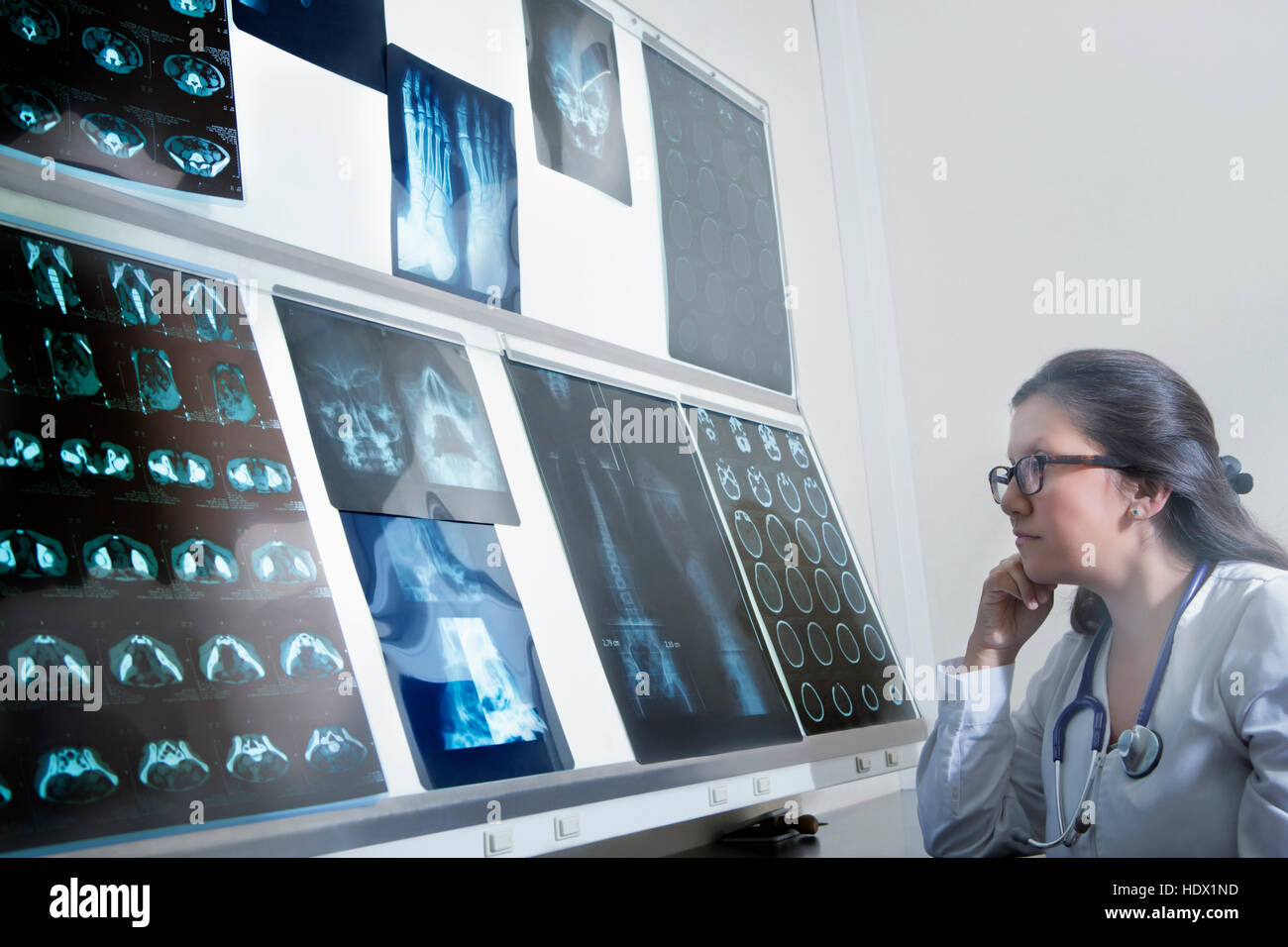 Hispanic doctor examining x-rays Stock Photo - Alamy