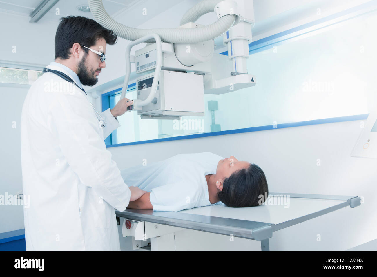 Hispanic doctor comforting patient at x-ray machine Stock Photo - Alamy